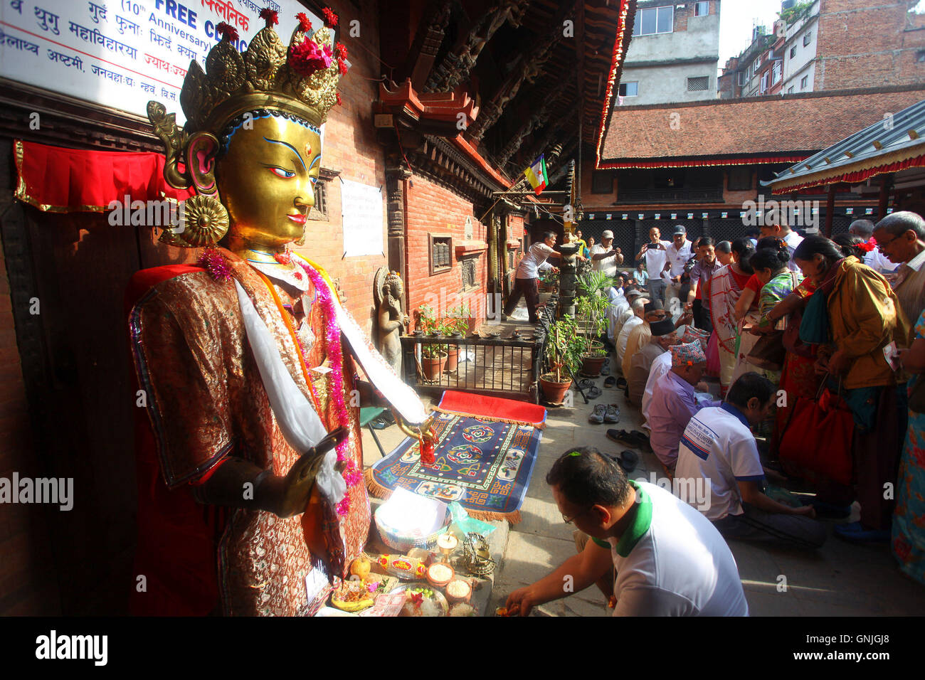 Kathmandu, Nepal. 30th Aug, 2016. Buddhists distribute offerings to ...