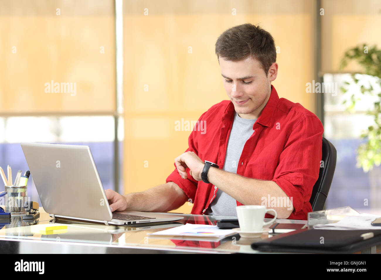 Businessman working and checking smart watch or clock sitting in a ...