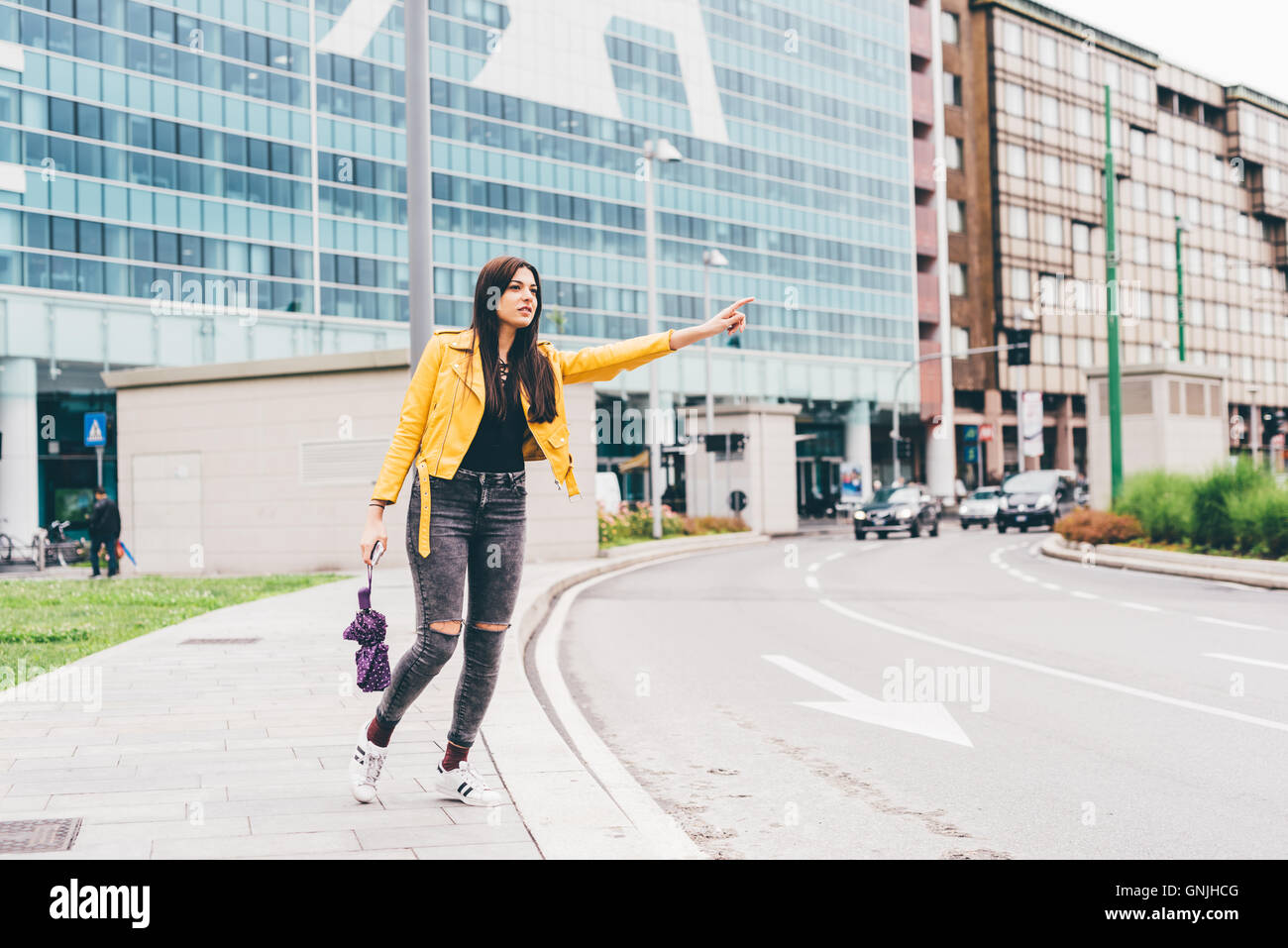 Young beautful caucasian brown long hair woman outdoor in the city ...