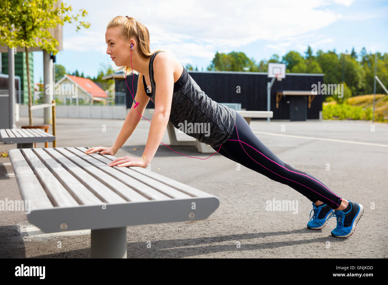 Woman Doing Pushups On Bench In Park Stock Photo - Alamy