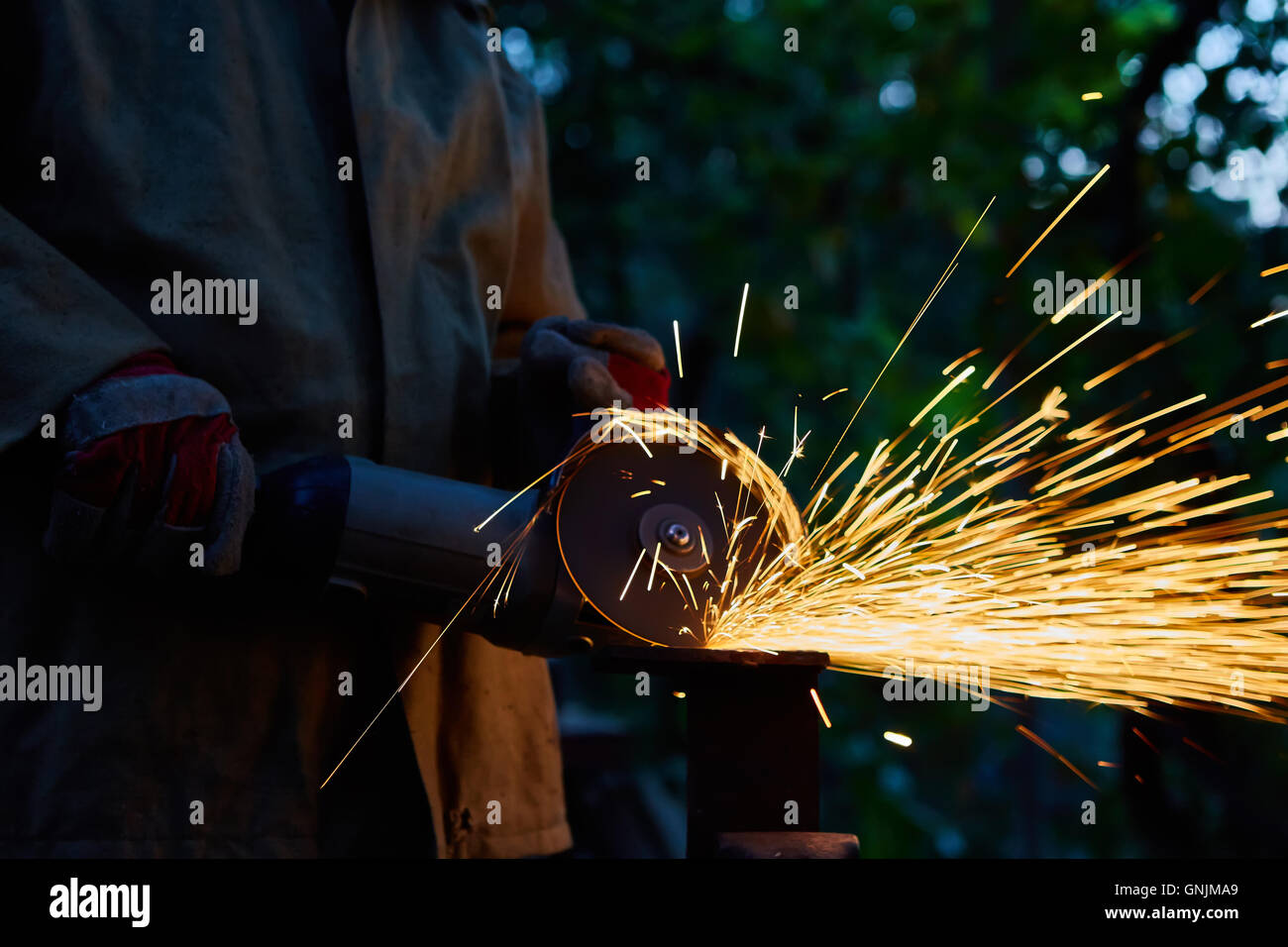 Worker cutting metal with grinder. Sparks while grinding iron Stock ...