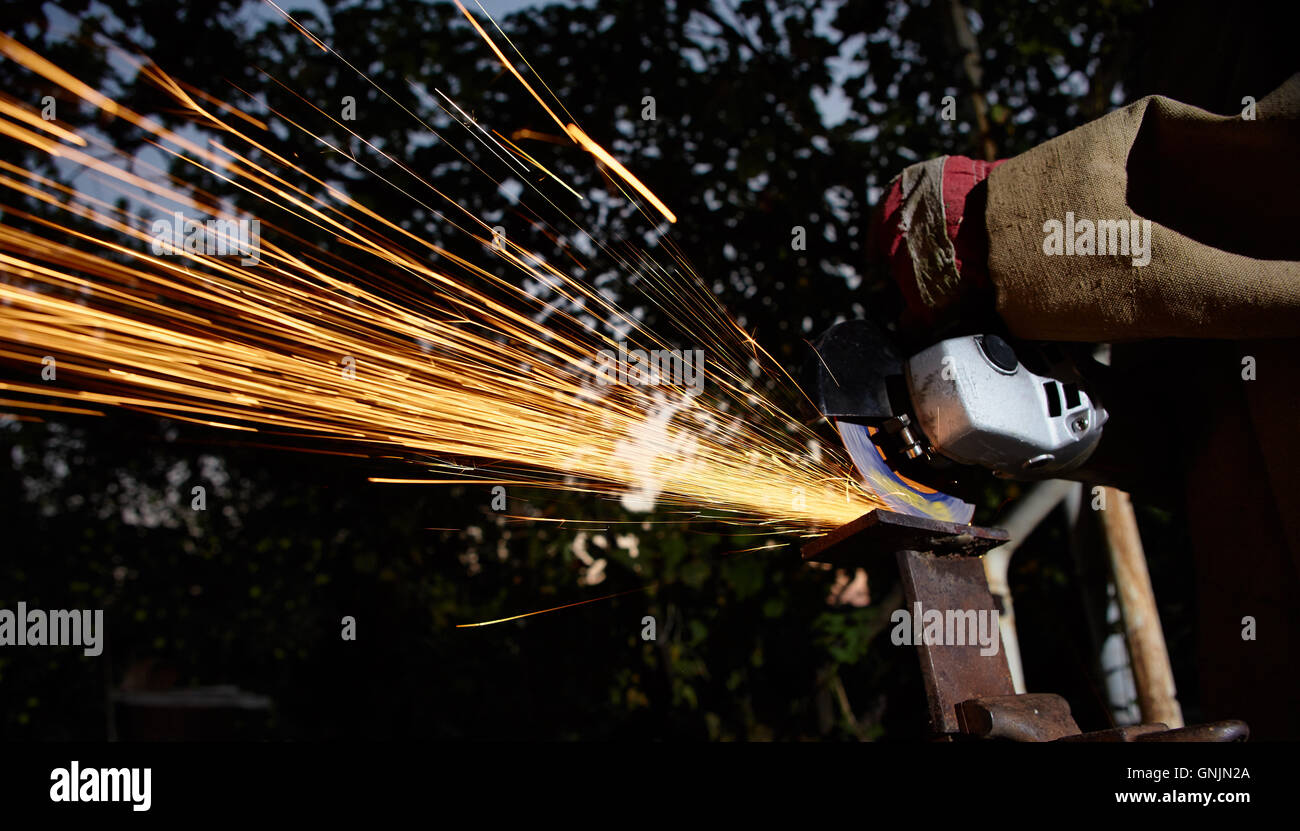 Worker cutting metal with grinder. Sparks while grinding iron Stock ...