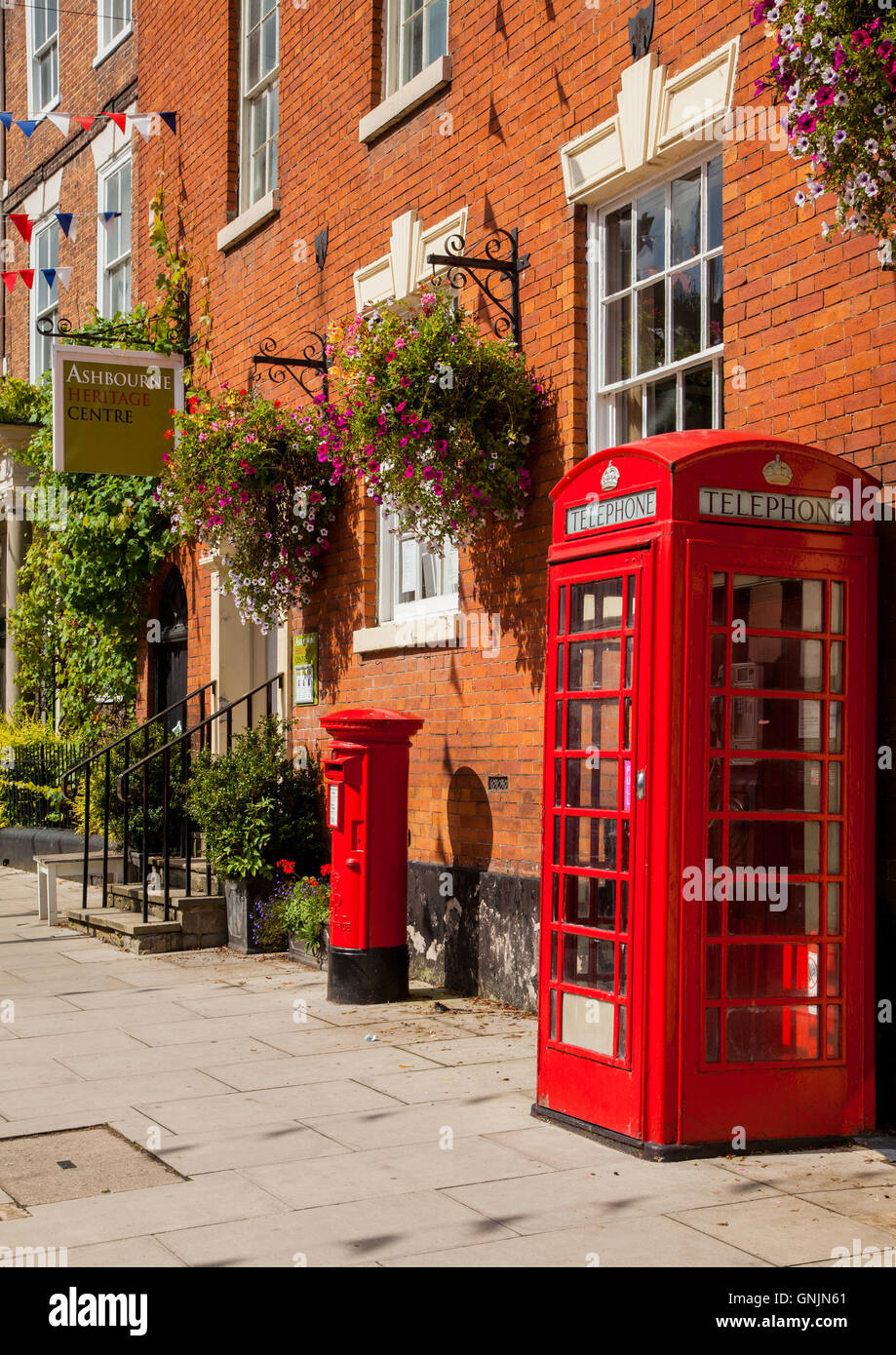 Red round post box and traditional red telephone box outside Ashbourne ...