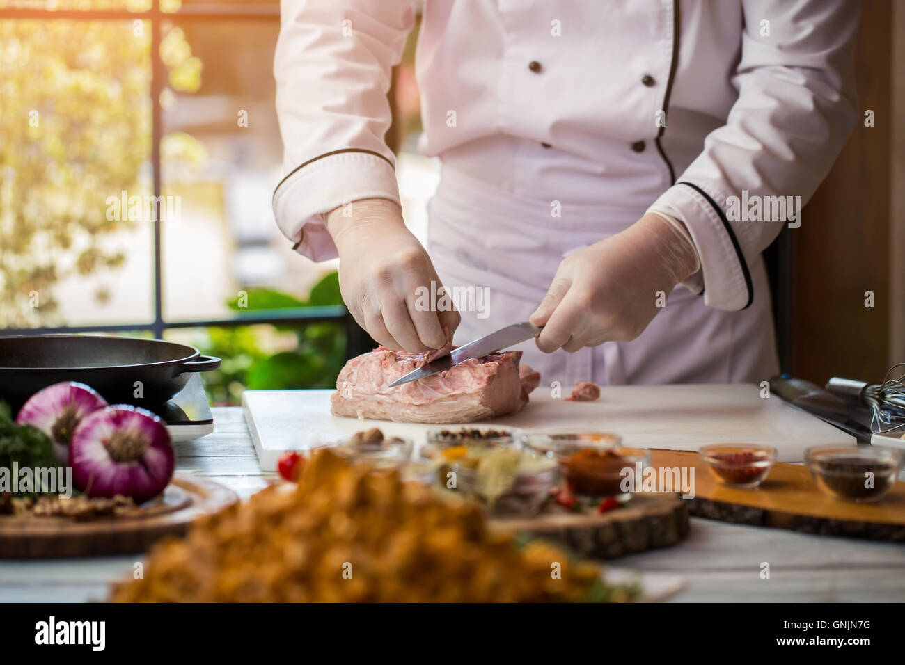 Man is cutting raw meat Stock Photo - Alamy