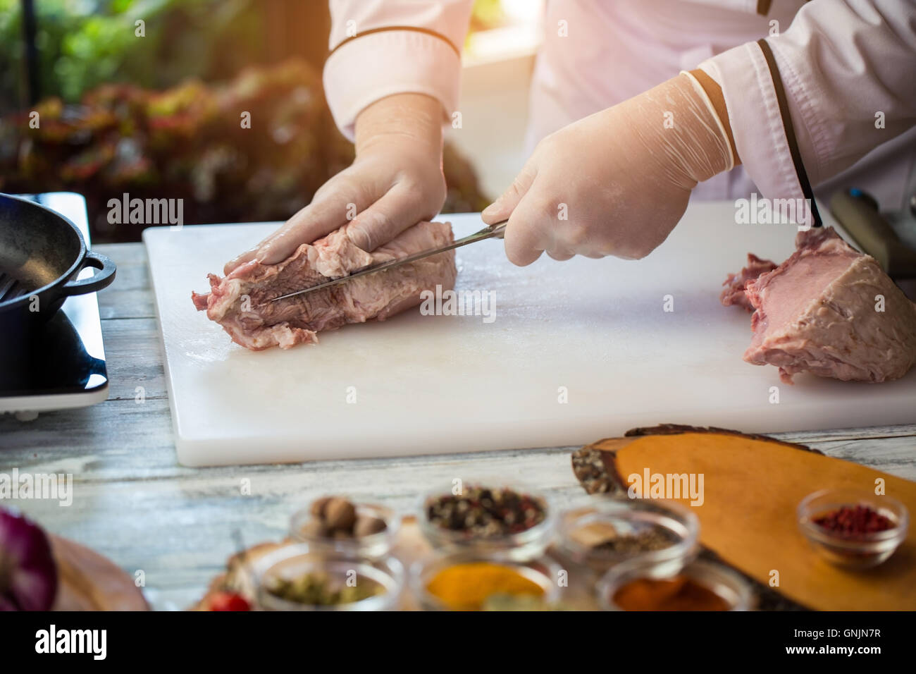 Knife is cutting raw meat Stock Photo - Alamy