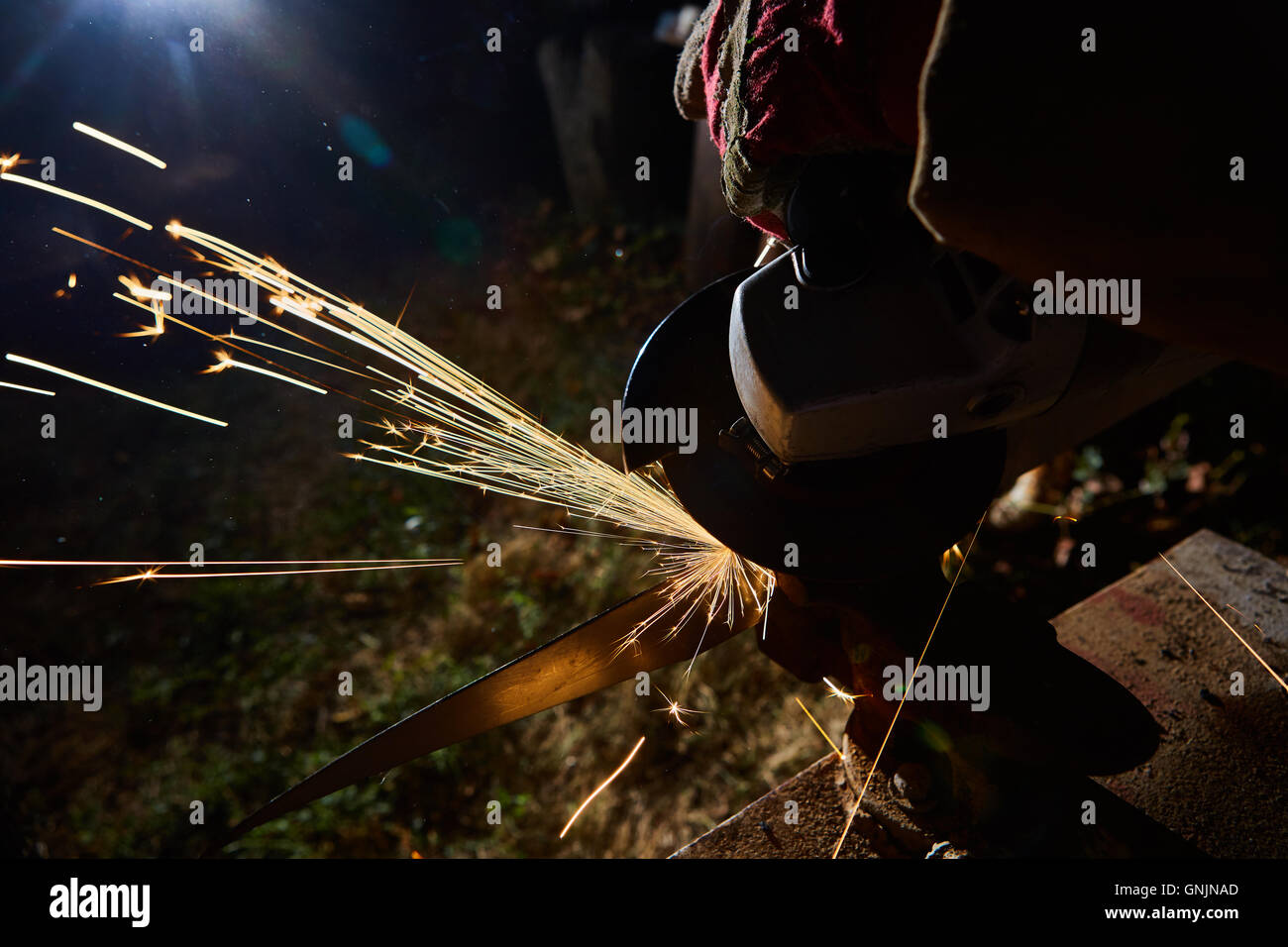 Worker cutting metal with grinder. Sparks while grinding iron Stock ...
