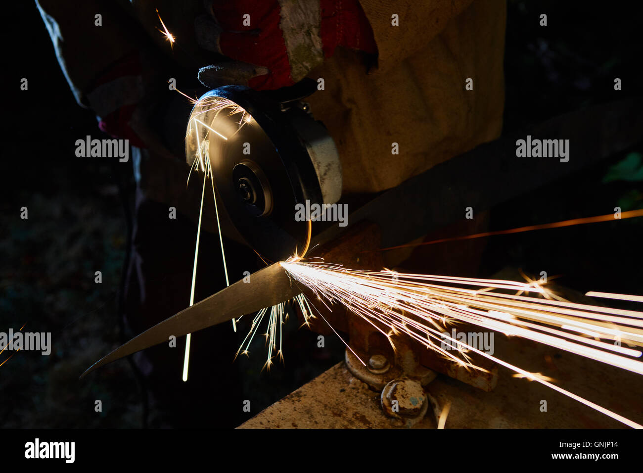 Worker cutting metal with grinder. Sparks while grinding iron Stock ...