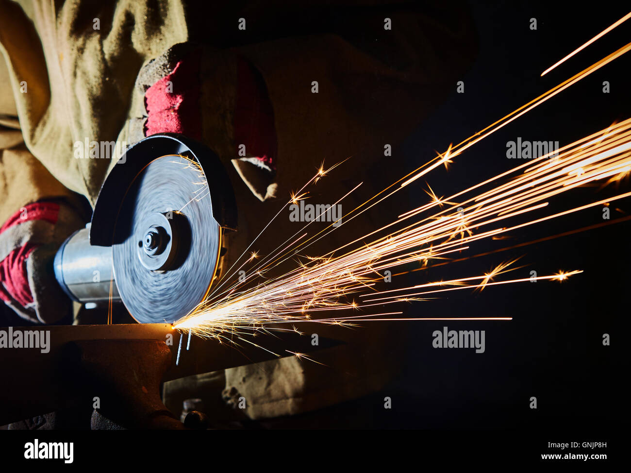 Worker cutting metal with grinder. Sparks while grinding iron Stock ...
