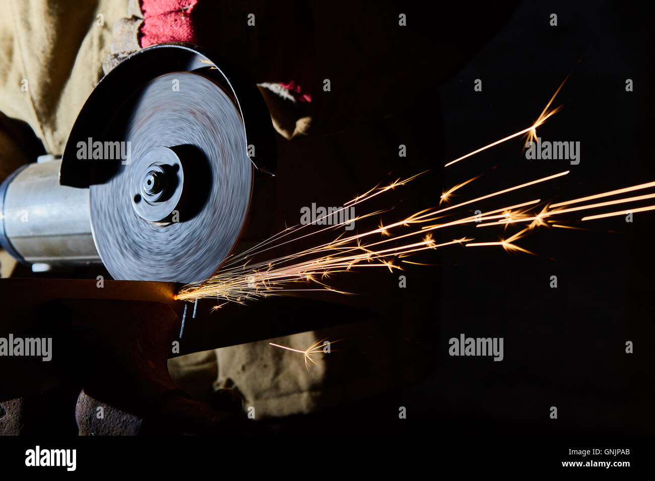 Worker cutting metal with grinder. Sparks while grinding iron Stock ...