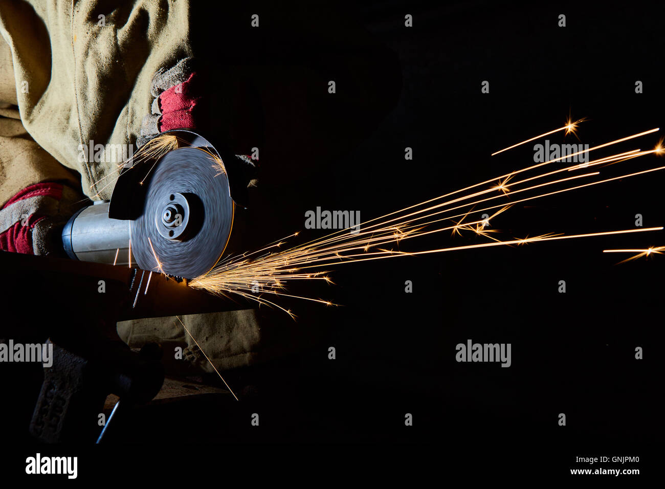 Worker cutting metal with grinder. Sparks while grinding iron Stock ...