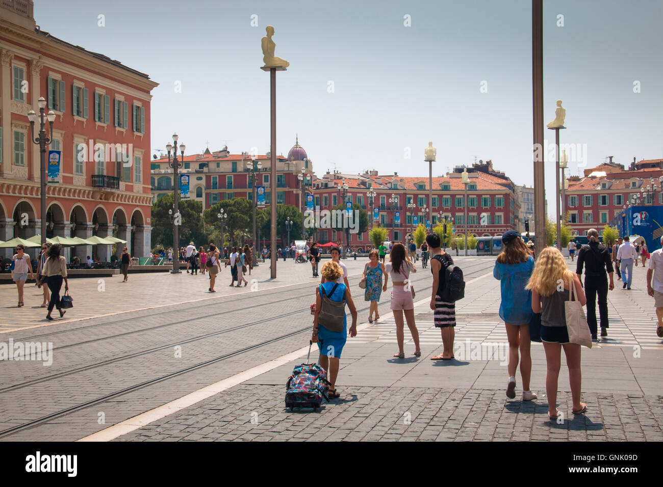 NICE, FRANCE - JULY 2016: People on the main square surrounded by ...