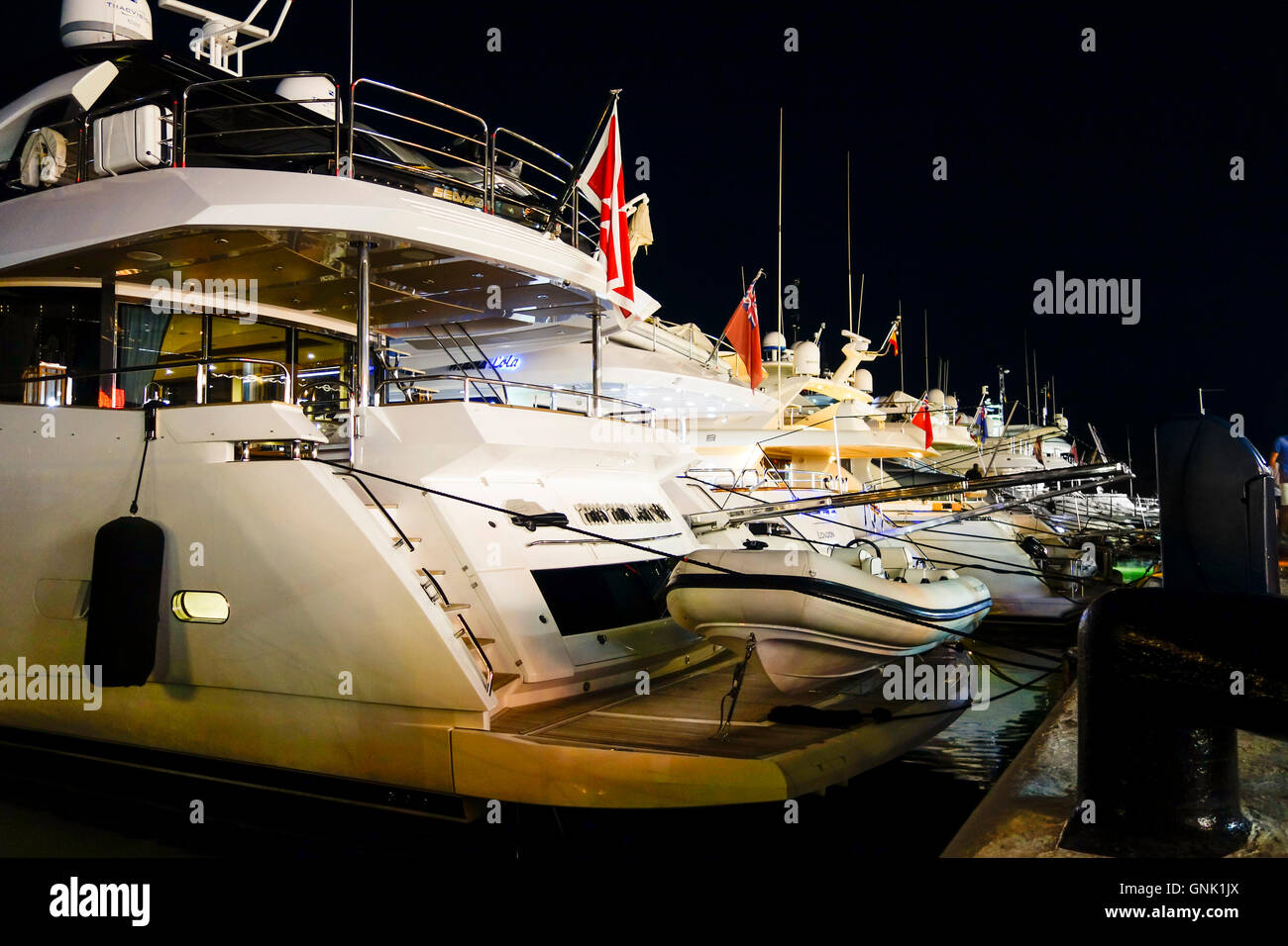 Yachts at Puerto Banus at night with nightlife and parties on boats ...