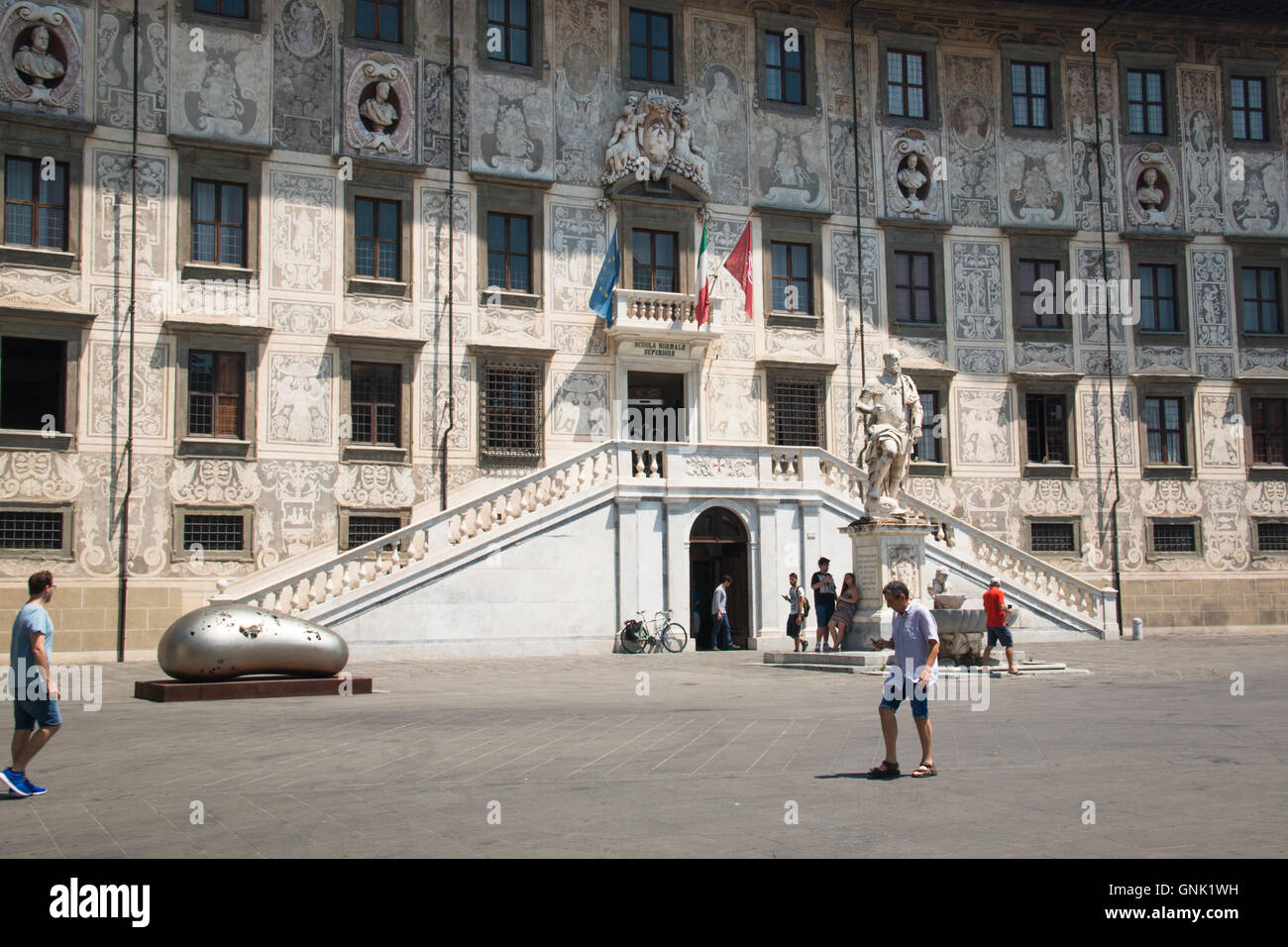 PISA, ITALY - JULY 2016: People passing by a square with historical ...