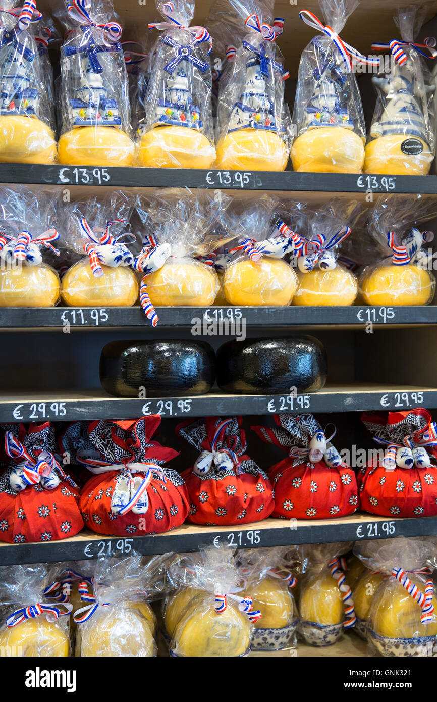 Gift wrapped cheese wheels as souvenirs and gifts on display shelves at ...