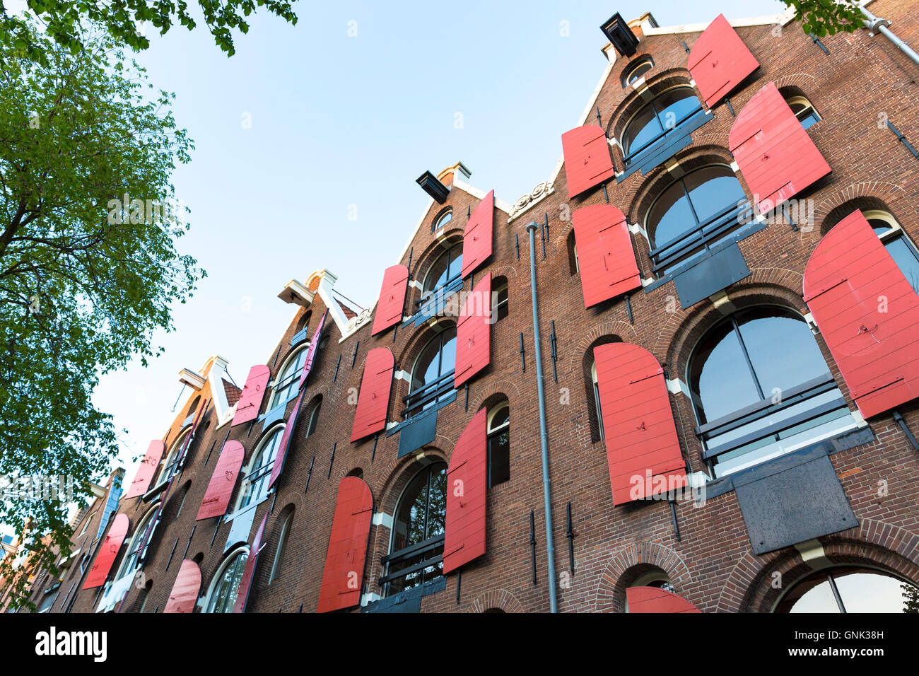 Red shutters and traditional Dutch architecture of canalside buildings ...