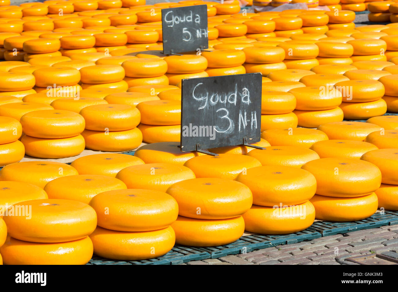 Traditional wheels of Gouda cheese on display on cobblestones at ...