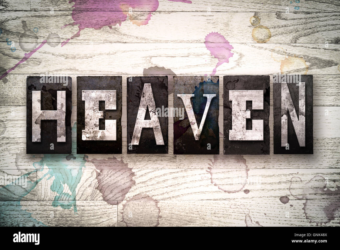 The word "HEAVEN" written in vintage, dirty metal letterpress type on a ...