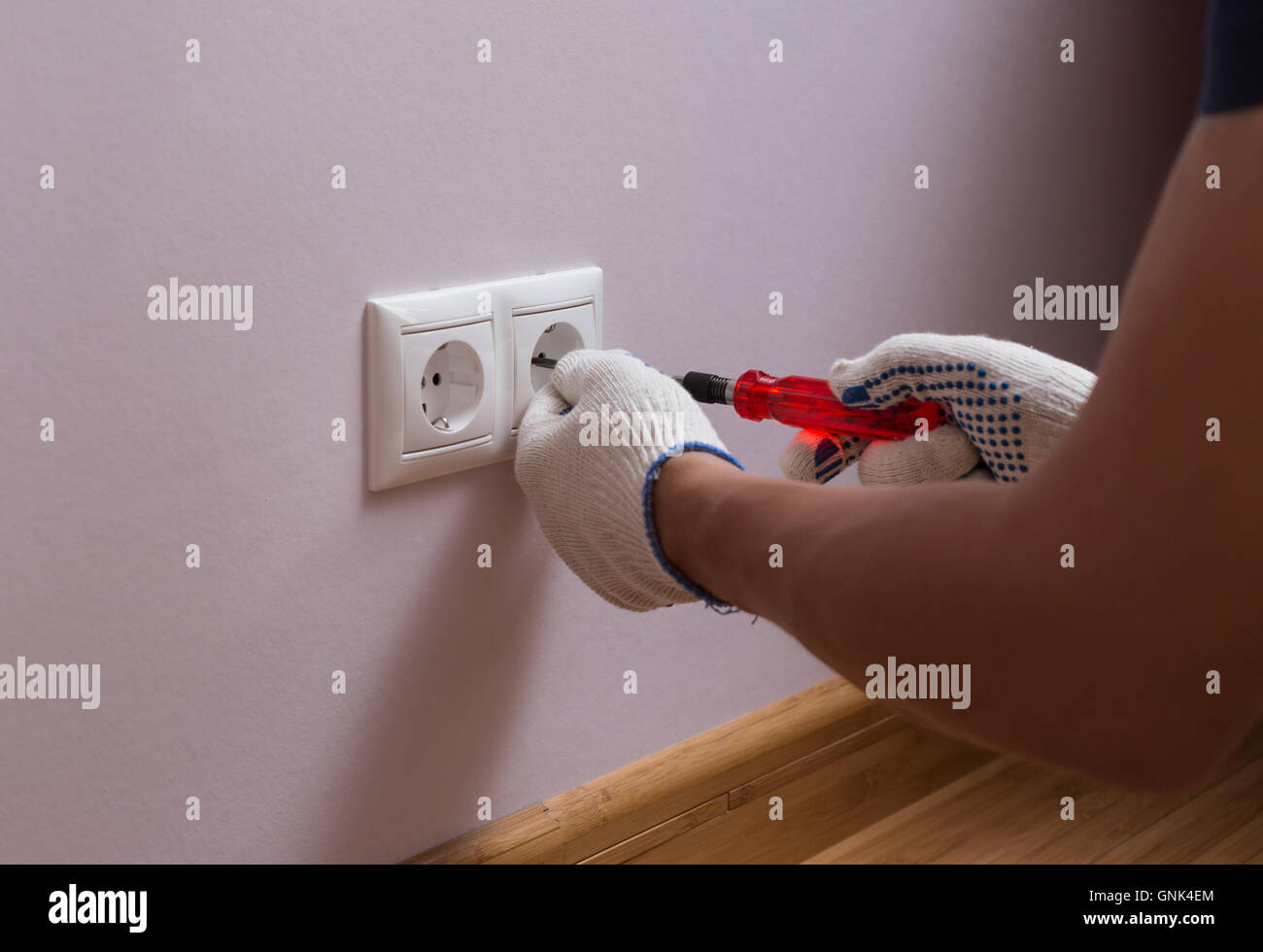 Electrician installing a wall power socket, close up photo Stock Photo ...