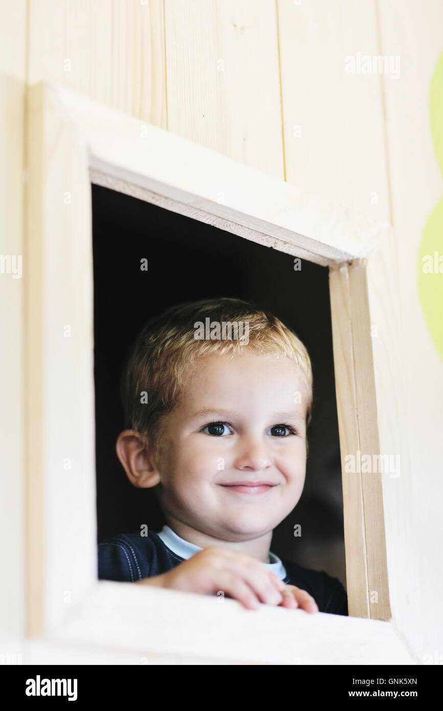 happy child in a window Stock Photo - Alamy