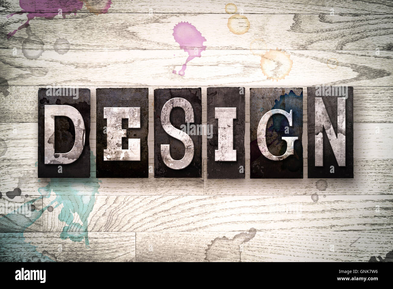 The word "DESIGN" written in vintage, dirty metal letterpress type on a ...