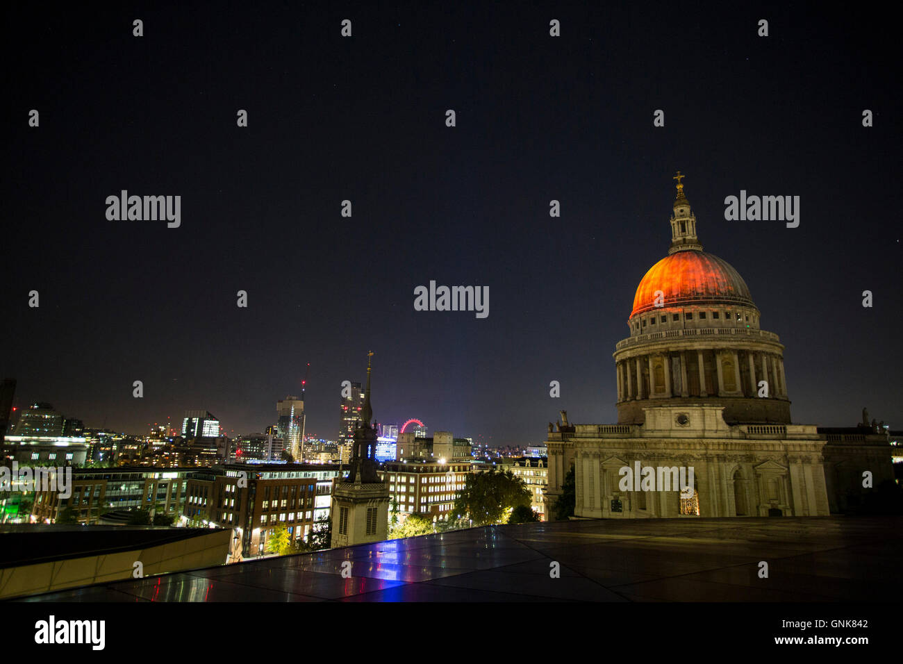 The dome of St Paul's Cathedral in London is lit up with a fiery ...
