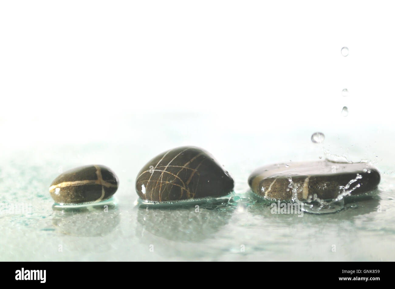 isolated wet zen stones with splashing water drops Stock Photo - Alamy