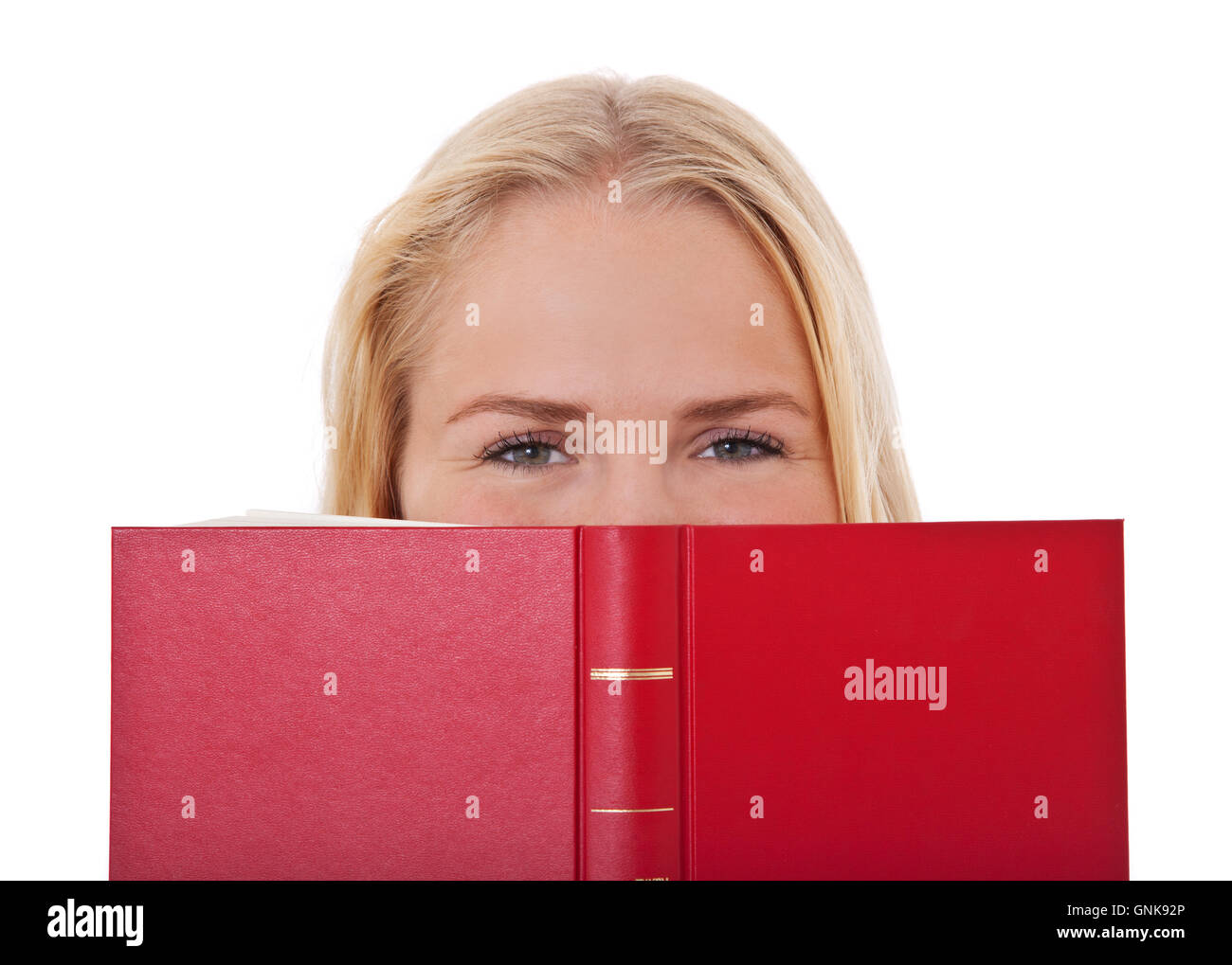 Girl hiding behind a book Stock Photo - Alamy