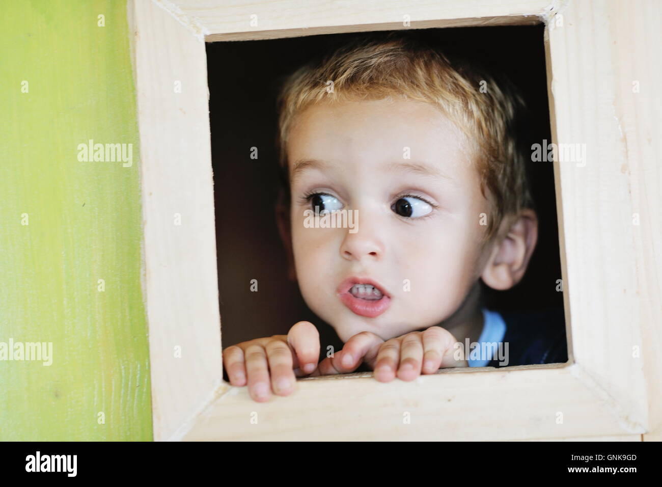 happy child in a window Stock Photo - Alamy