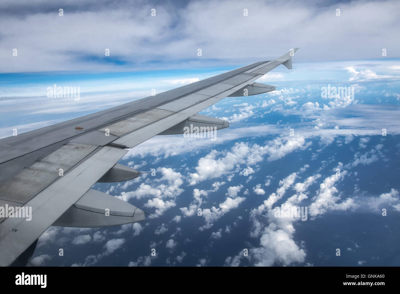 A view of a passenger jet wing as seen from the cabin during flight ...