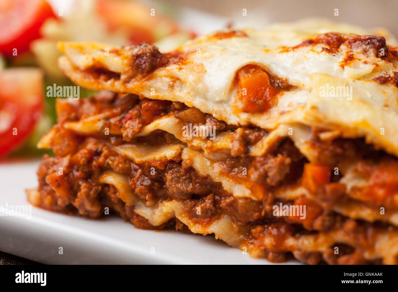 italian lasagna on a square plate Stock Photo - Alamy