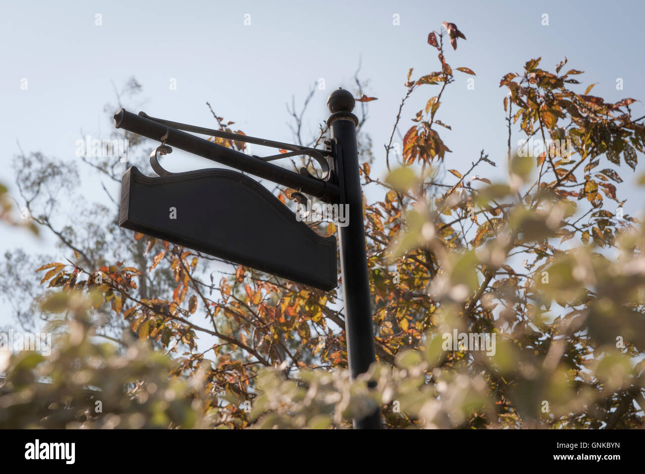 Sign hanging on a pole outdoors in a garden Stock Photo - Alamy