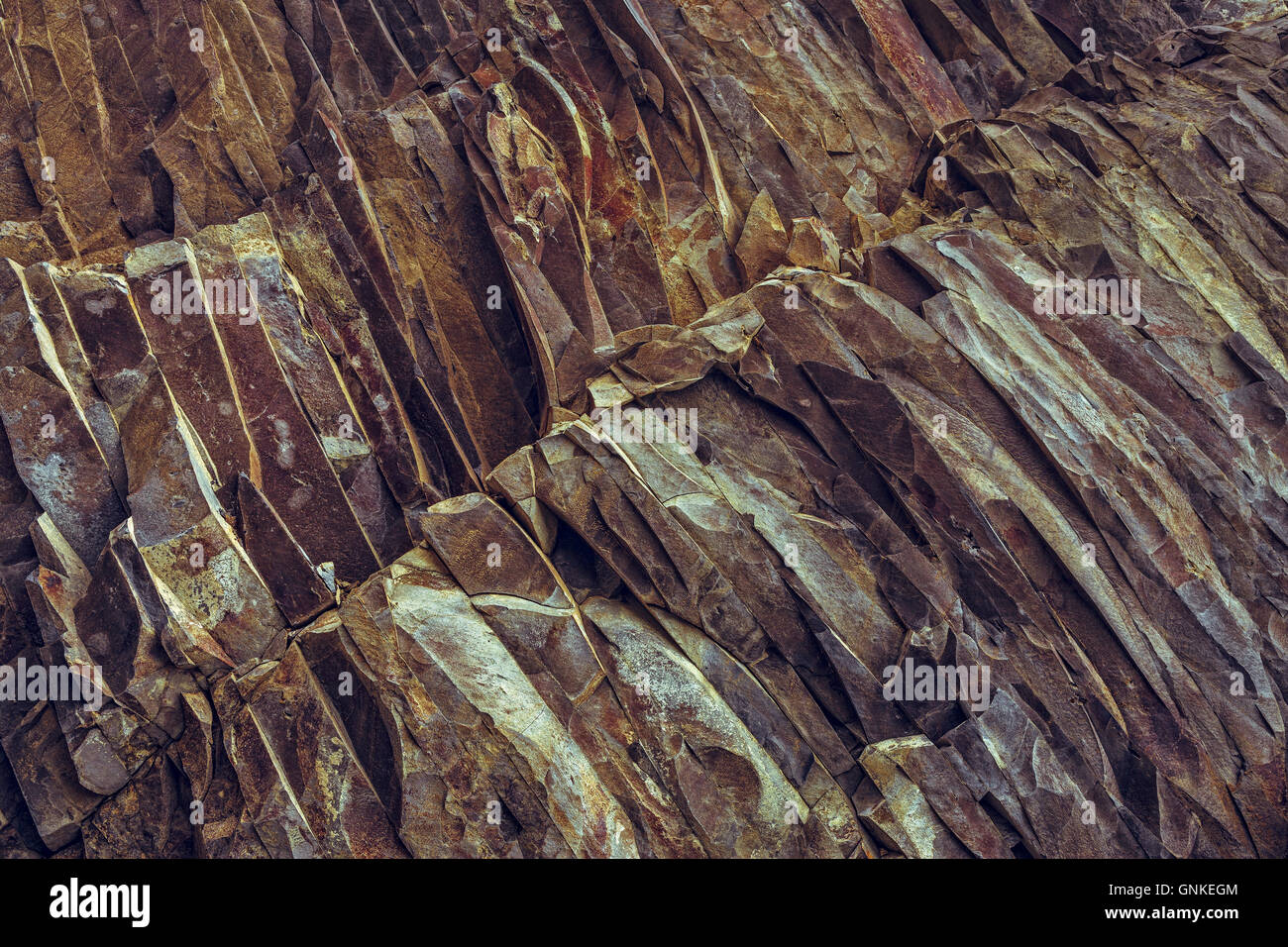 Ferric rock layers detail in a basalt quarry. Rusty rock layers ...