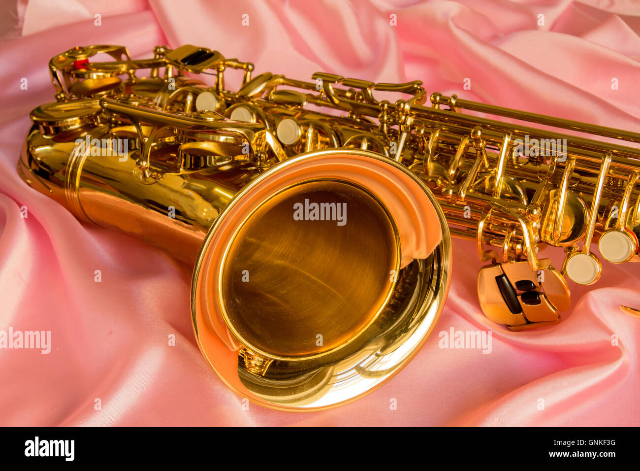 saxophone on delicate Pink silk Stock Photo - Alamy