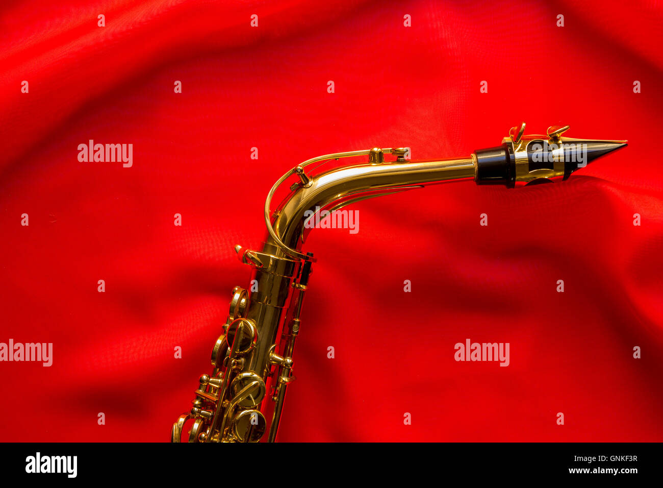saxophone on delicate red silk Stock Photo - Alamy