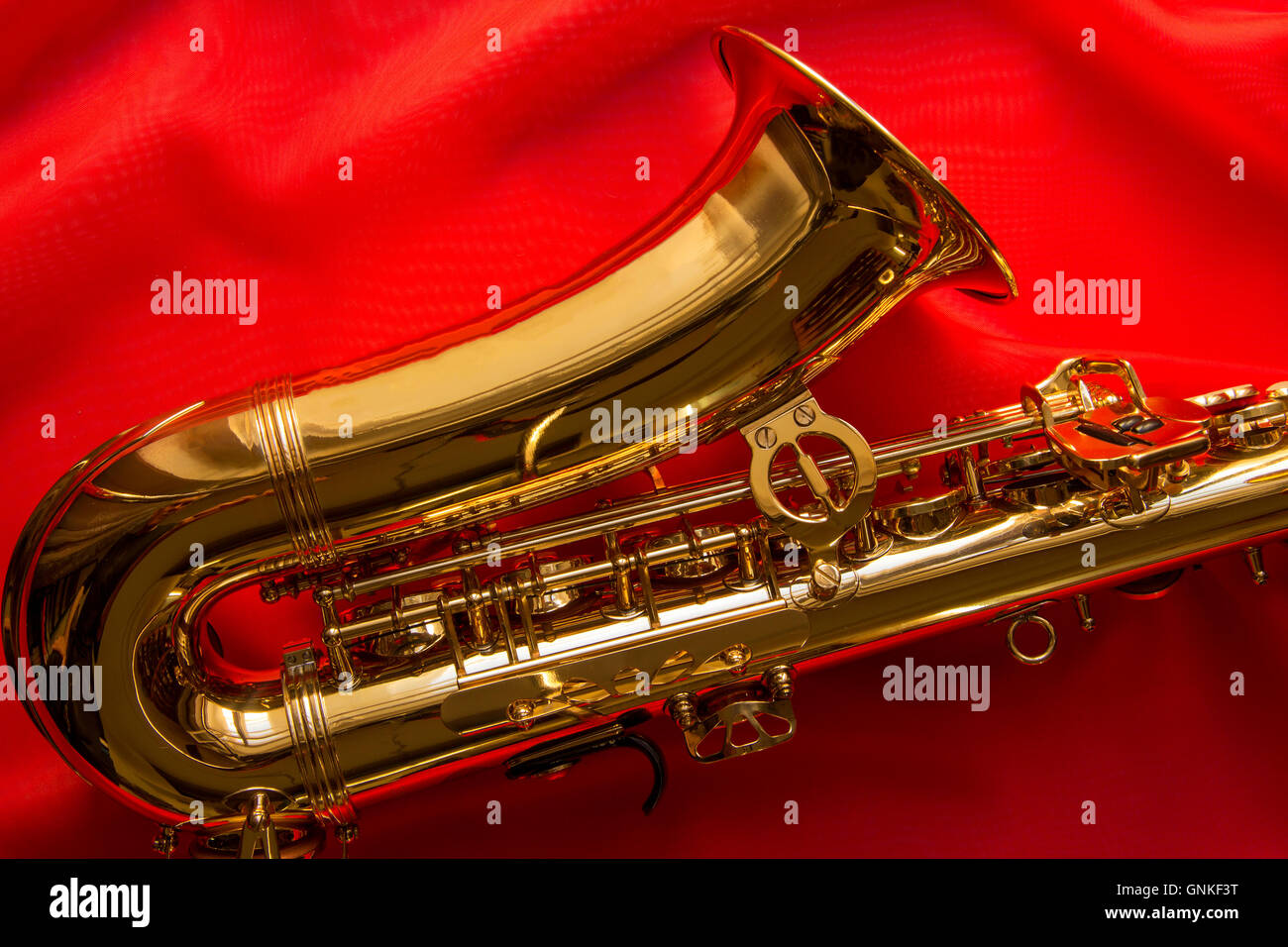 saxophone on delicate red silk Stock Photo - Alamy