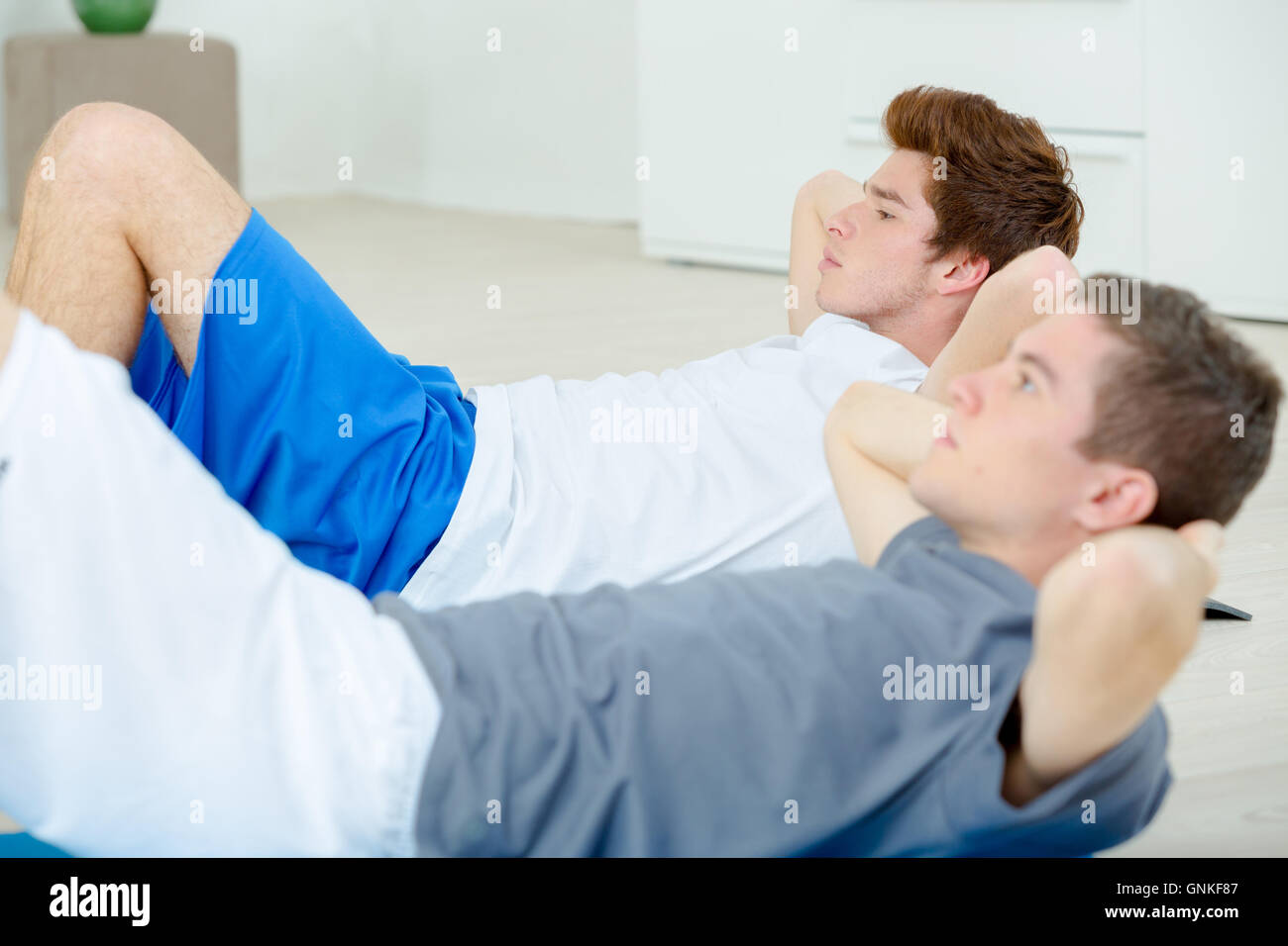 Two men doing sit-ups Stock Photo - Alamy