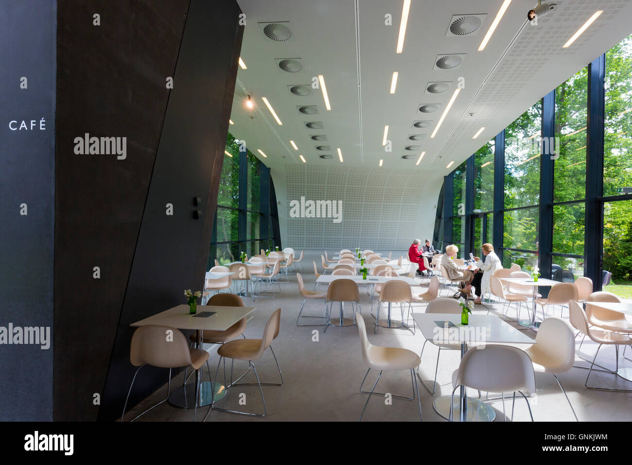 Table and chairs in cafe in building designed by architect Zaha Hadid ...
