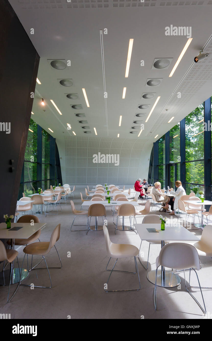 Table and chairs in cafe in building designed by architect Zaha Hadid ...