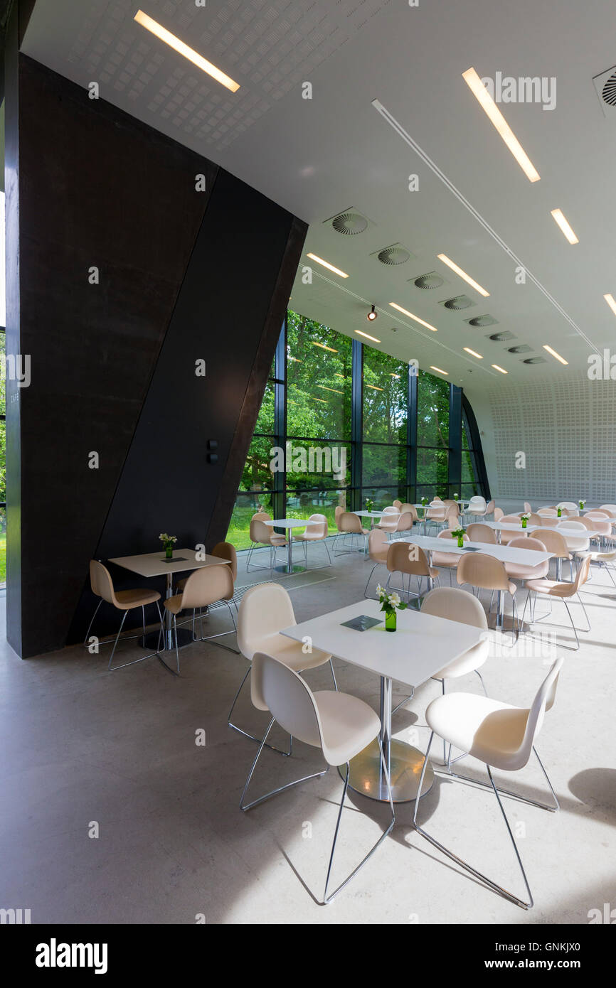 Table and chairs in cafe in building designed by architect Zaha Hadid ...
