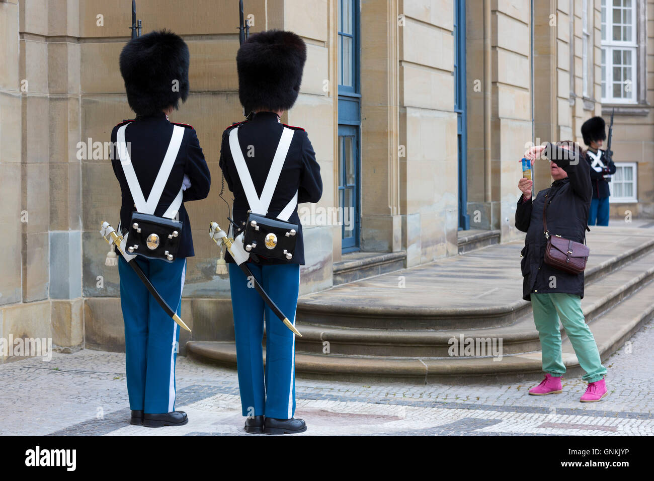 Tourist taking photograph of Danish army sentry soldier in uniform at ...