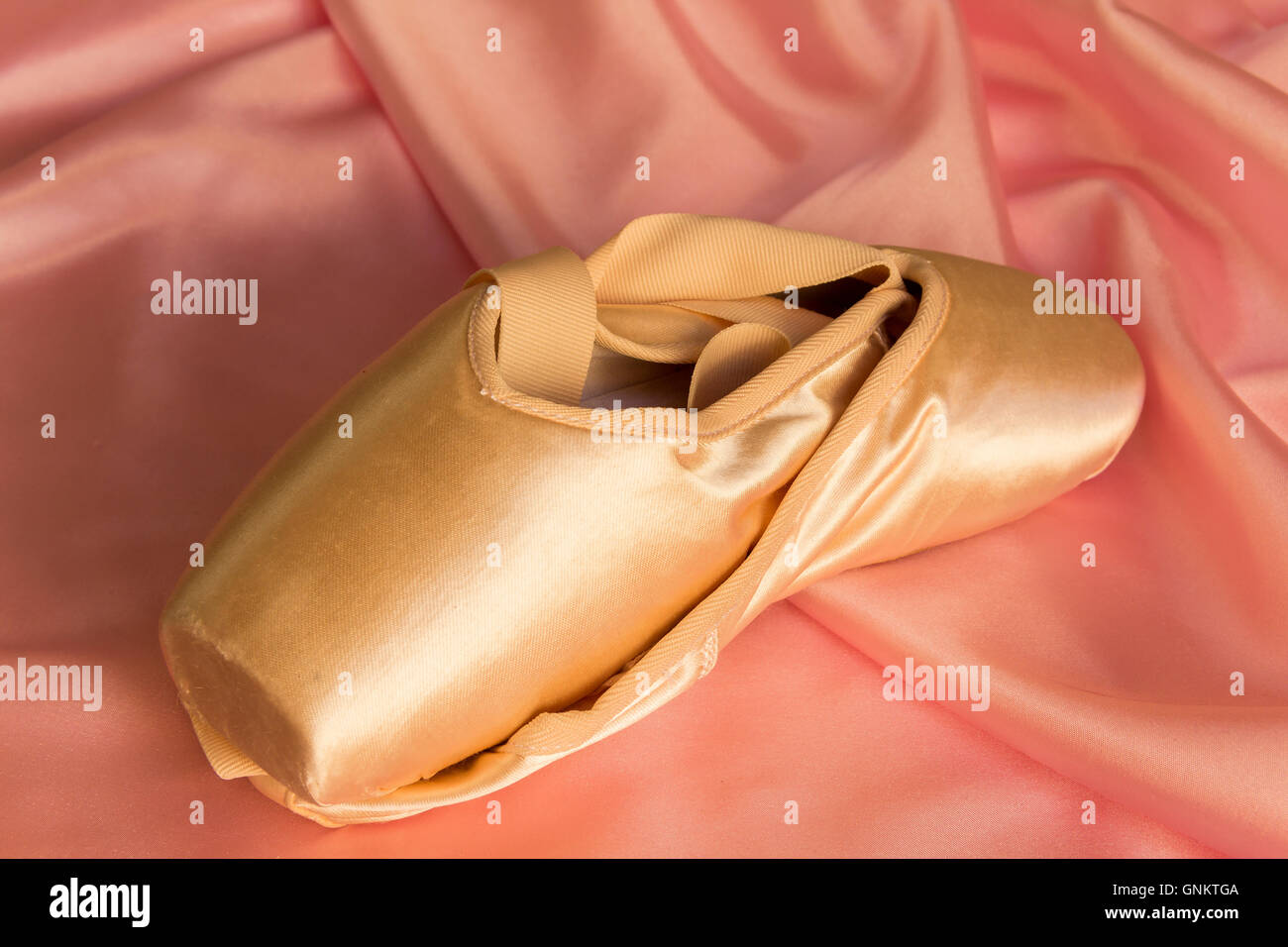 Ballet shoes on silk pink background Stock Photo - Alamy