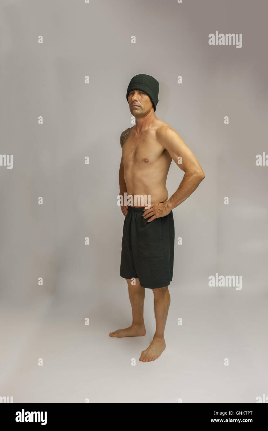 Shirtless middle age man showing muscles with hands on hips Stock Photo ...