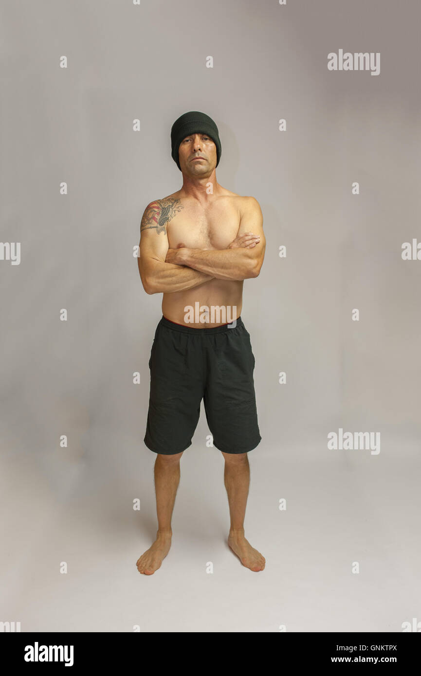 Shirtless middle age man showing muscular chest Stock Photo - Alamy