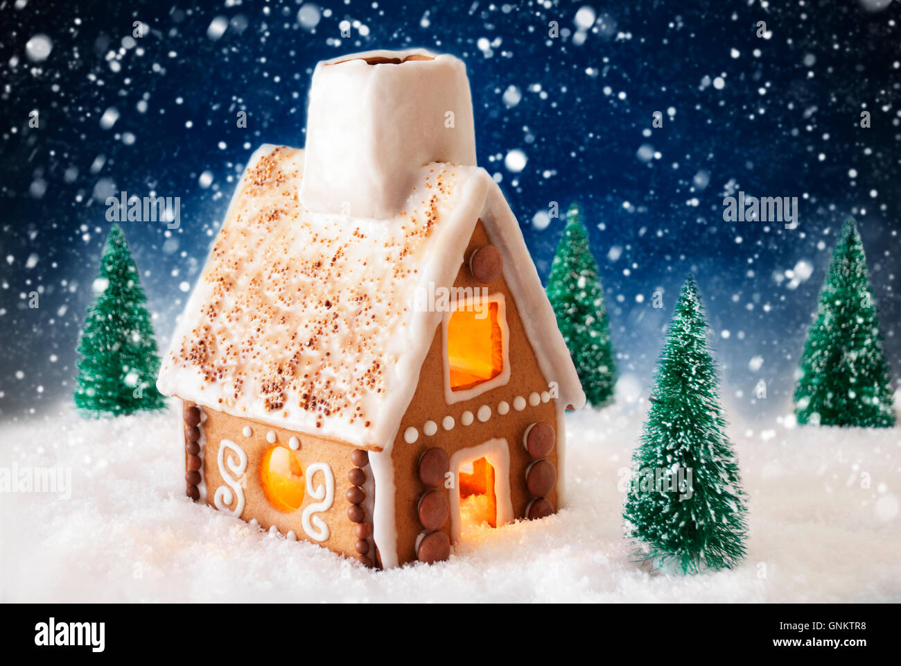 Gingerbread House On Snow With Snowflakes And Blue Background Stock ...
