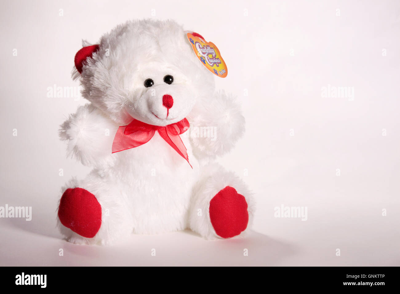 White teddy bear with read feet Stock Photo - Alamy