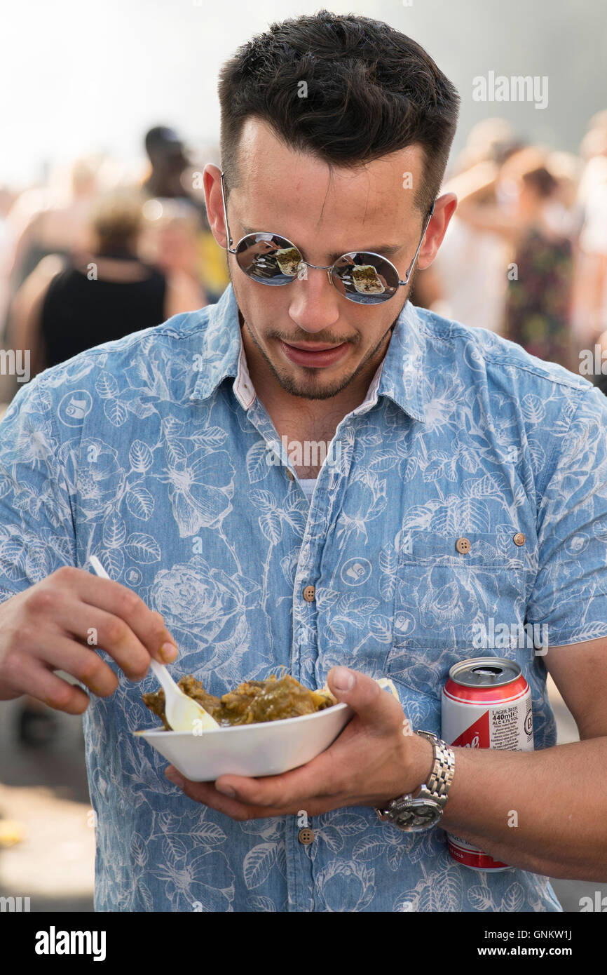 Man eating street food at Notting Hill Carnival in London Stock Photo ...