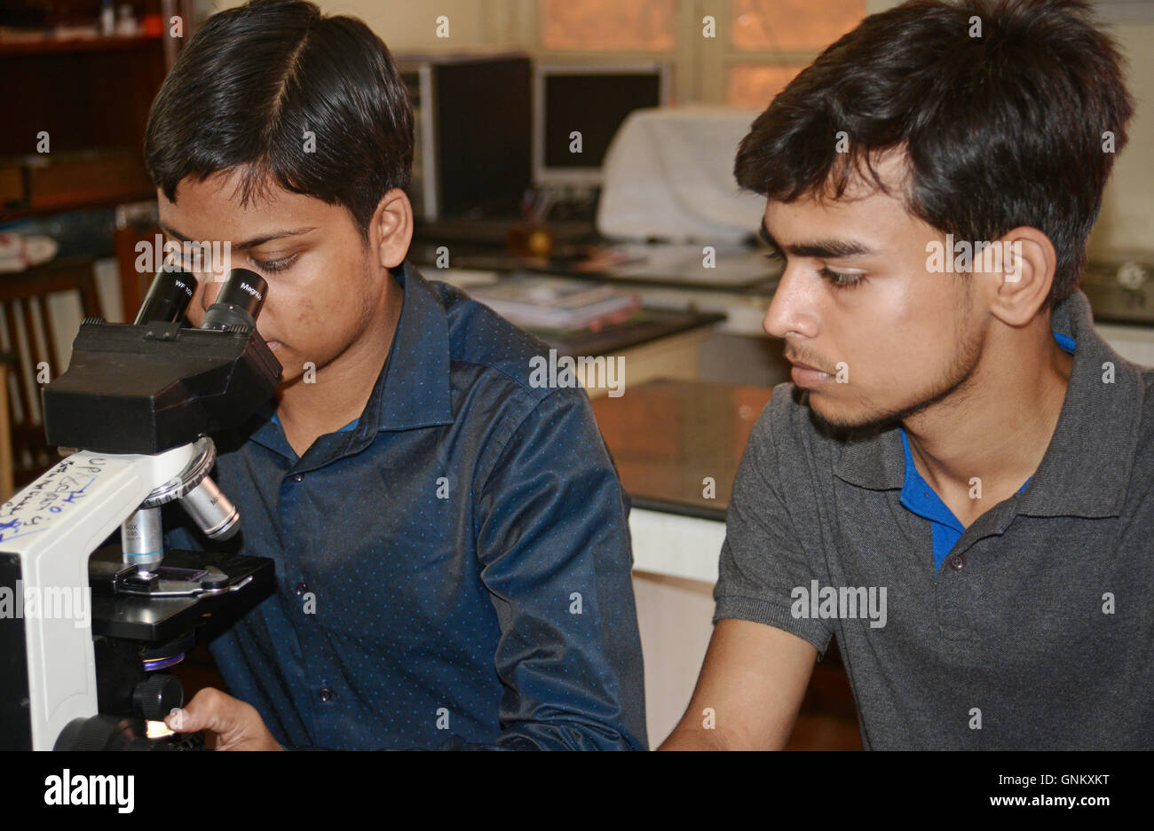 Student working in classroom Stock Photo - Alamy
