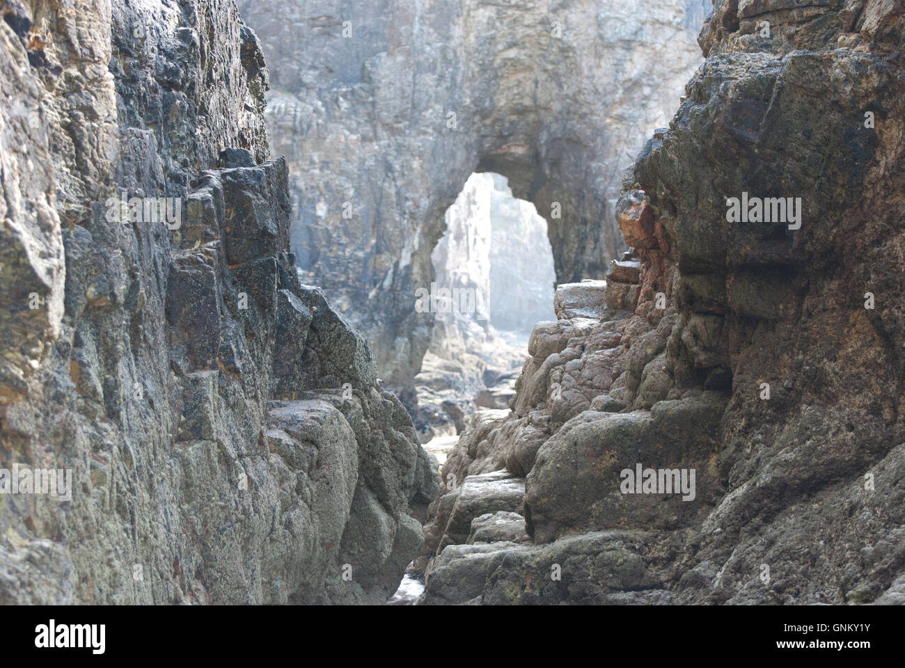 Light shining through Rock formation at Paranporth Beach, Cornwall ...