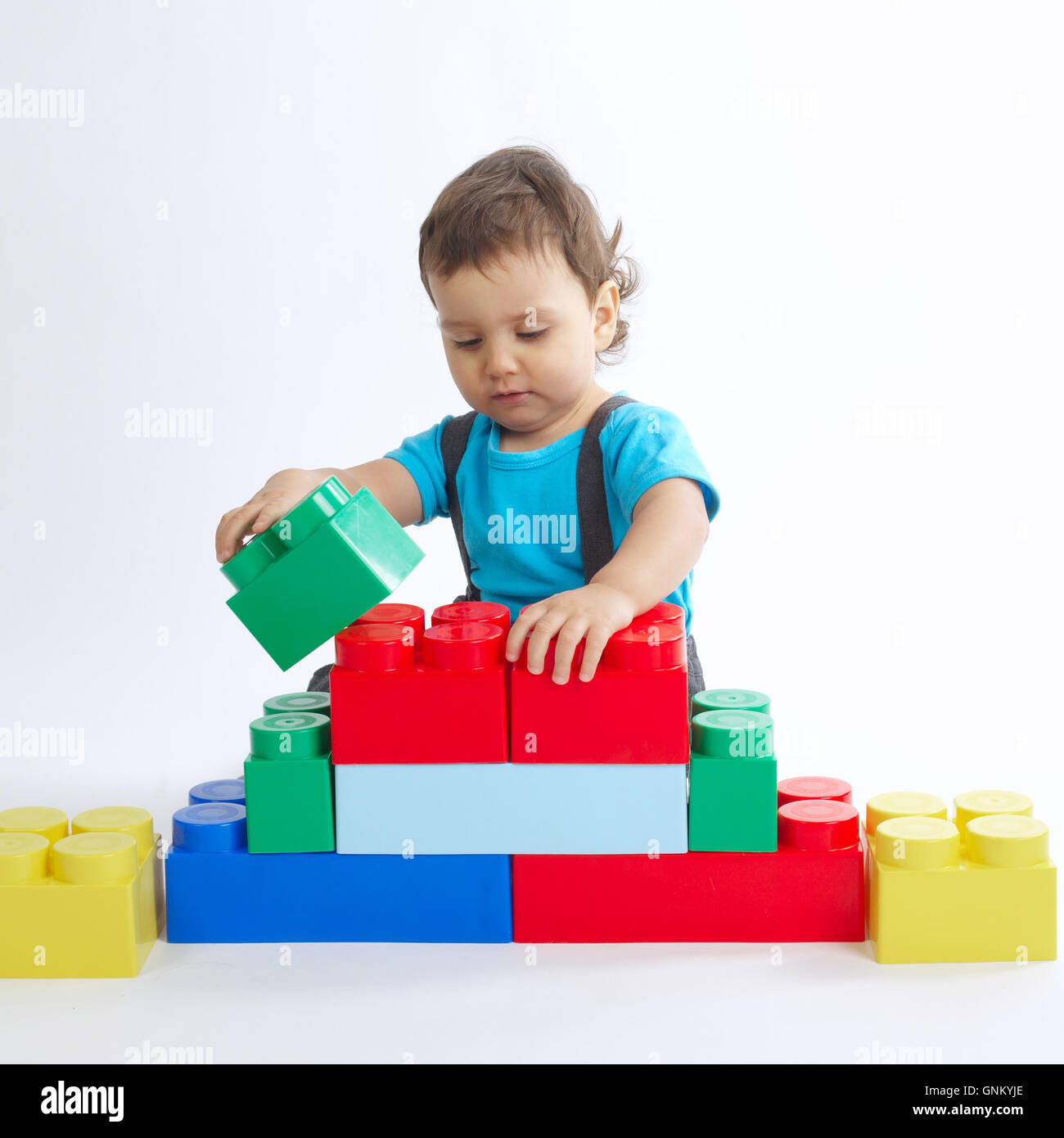 little boy plays with colorful cubes Stock Photo - Alamy