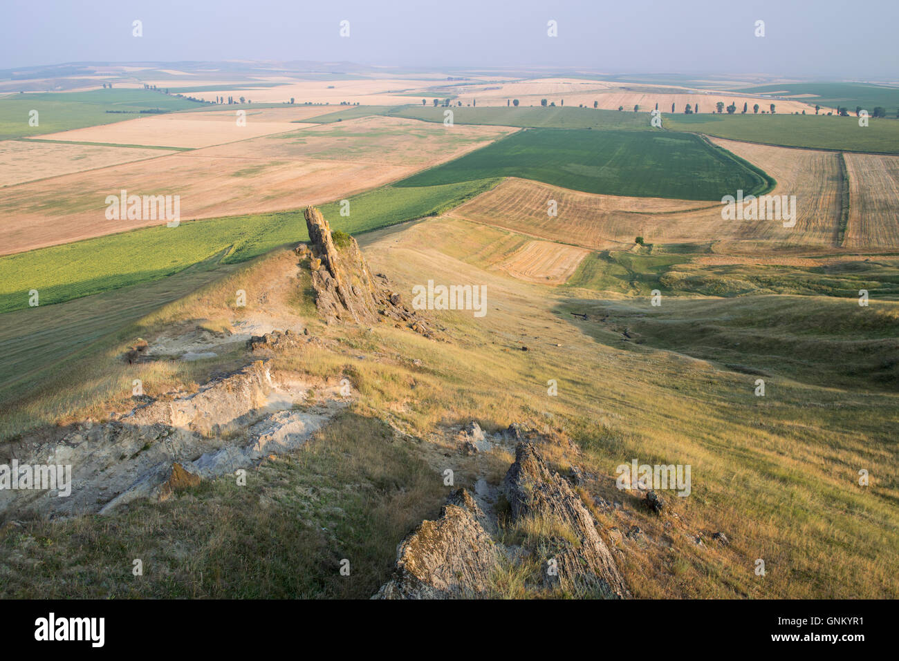 Beautiful rocks on the hill and golden fields, natural geological ...
